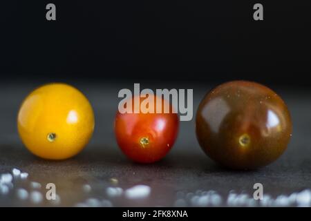 three natural yellow tomatoes, close-up, on a white background Stock ...