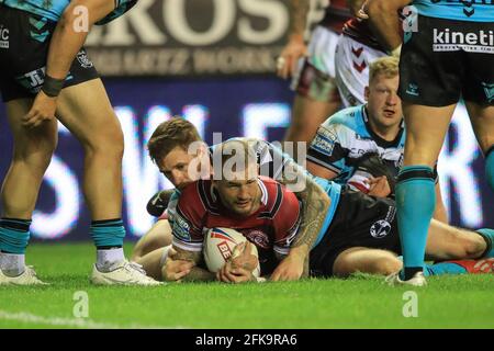 Zak Hardaker of Hull FC is tackled by Max Jowitt of Wakefield Trinity ...