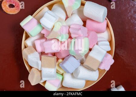 Cup with different tasty candies on color background Stock Photo - Alamy