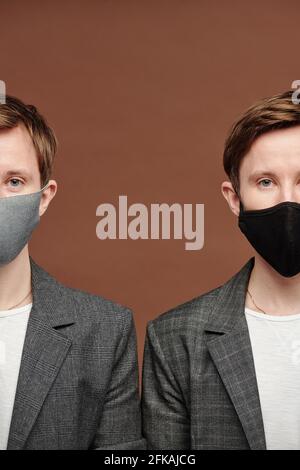 Portrait of men with facial masks against purple background Stock Photo ...