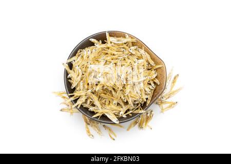 Dry anchovy (stolephorus indicus) fish in ceramic bowl isolated on ...