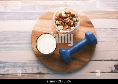 dumbbell, almond nut and milk on black background Stock Photo - Alamy