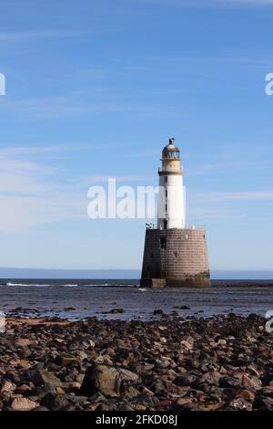White lighthouse on pedestal in sea Stock Photo - Alamy