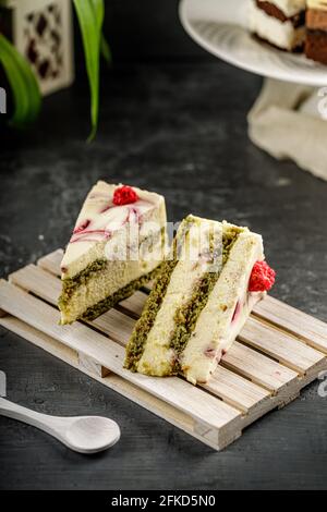 Tasty cake with pistachio and strowberry on the wooden pallet. Sweet ...