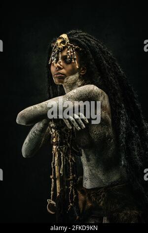 Portrait of a shaman covered in clay, wearing dreadlocks and bone ...