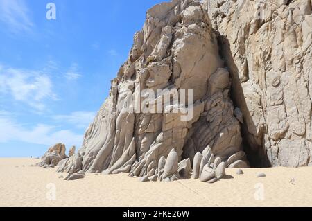 Pacific ocean and beach with golden sands and limestone rock formations ...