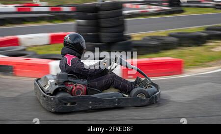A panning shot of a racing kart as it circuits a track Stock Photo - Alamy