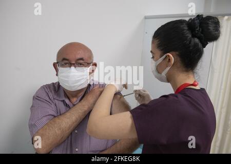 Turkish nurse vaccinates a man against COVID-19 with Pfizer BioNTech ...
