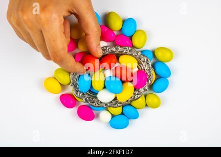 Woman picking a candy in candy bowl in focus on white background Stock ...