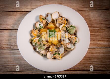 Steamed cockles with fried potatoes in the white dish, mariniere recipe ...