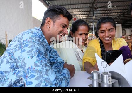 Group of happy cheerful young Indian friends having fun in a cafe Stock ...