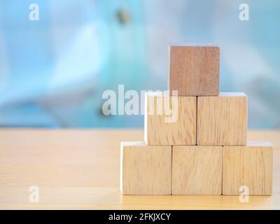 Hand arranging wood cube stacking as step stair Stock Photo - Alamy