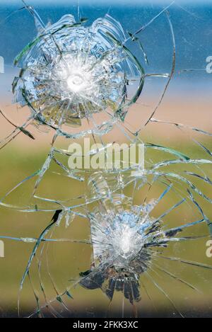 Impact fractures on window Stock Photo - Alamy