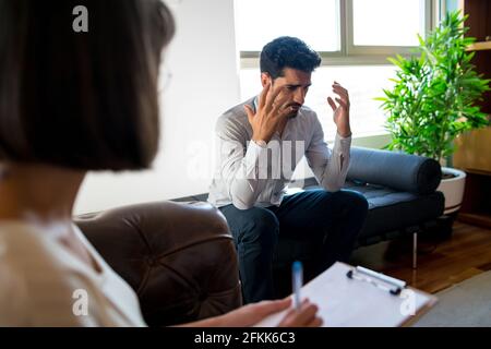 Psychologist taking notes during therapy session Stock Photo - Alamy