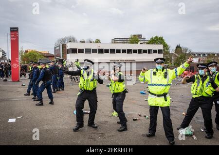 Police officers move in to disperse a crowd of protesters who blocked ...