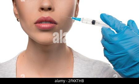 Close up of cosmetic botox injection in female lips. Front view of ...