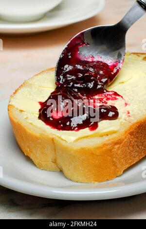Spread jam on bread Stock Photo - Alamy