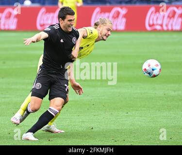 Inter Miami forward Robbie Robinson, left, runs with the ball as ...