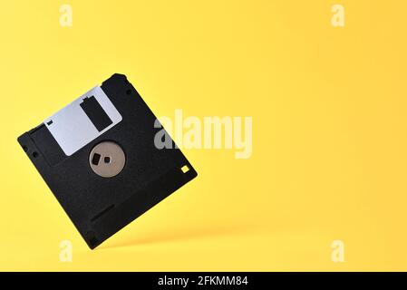 Floppy disk on yellow background. Retro computer diskette Stock Photo ...