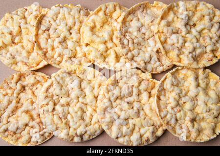 Circle shaped salty corn snacks making background Stock Photo - Alamy