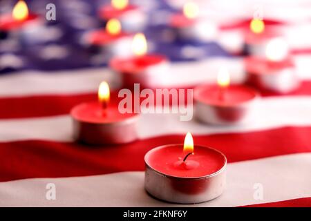 Mourning candles burning on USA American national flag background ...