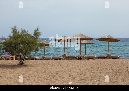 View of sandy Soros Beach on the Greek island of Antiparos with sunbeds ...