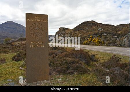 Sign for Mackay Country with blurred background of road and mountains ...