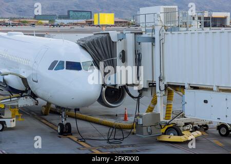 Jetway connected to the airplane for boarding passengers. Boarding ...