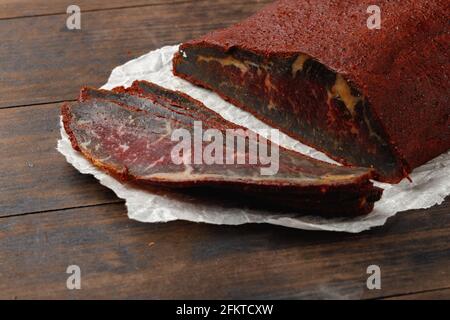 Sliced basturma meat on brow wooden background Stock Photo - Alamy