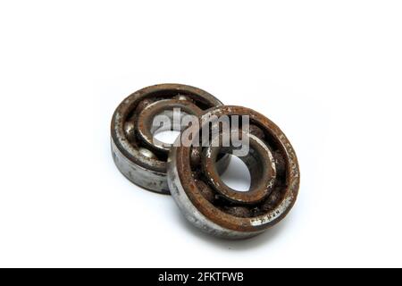 The rusty old bearings isolated in a white background. Jammed and ...