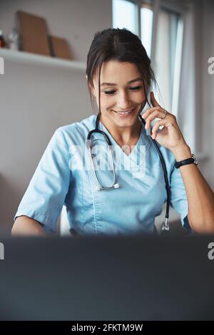 Young nice woman doctor having a conversation with her patient in ...