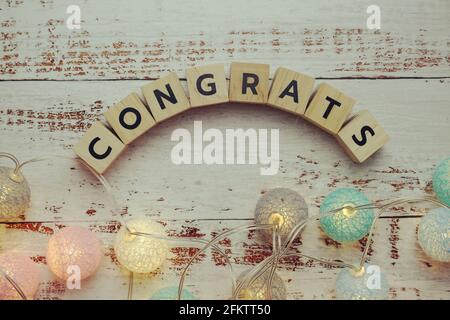 Congrats alphabet letter and LED cotton balls on wooden background ...