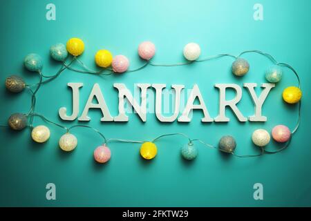 January alphabet letter with cotton ball LED decoration on blue ...