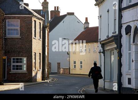 Man walking in the village of Cawood, North Yorkshire, England UK Stock ...