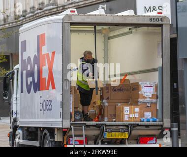 FedEx Express delivery truck unloading at receiving dock of commercial ...