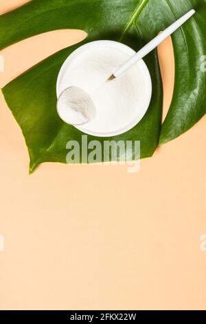 Collagen powder dietary supplement at pastel background Stock Photo - Alamy
