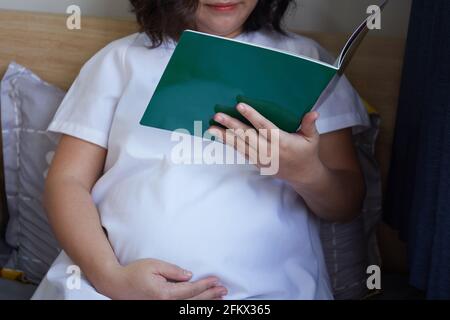 Pretty young Vietnamese woman reading text message on her phone when ...