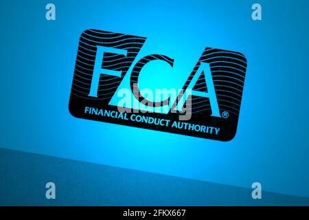 FCA Financial Conduct Authority logo on the smartphone and finger ...