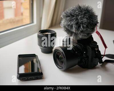 View of a black microphone on a table stand isolated on a white ...