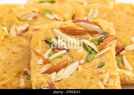 Soan Papdi is a popular Indian cube shape flakey crispy dessert. Served ...