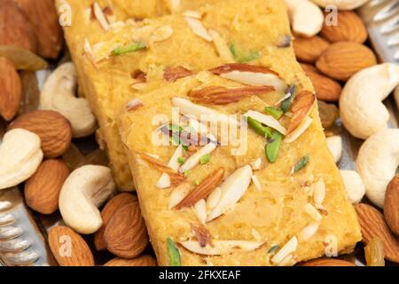 Soan Papdi is a popular Indian cube shape flakey crispy dessert. Served ...