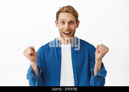 Amazed, fascinated good-looking redhead teenage girl celebrating ...