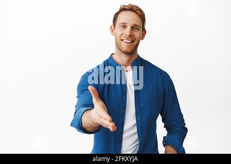 Friendly nice guy extend hand for handshake, greeting you and smiling ...