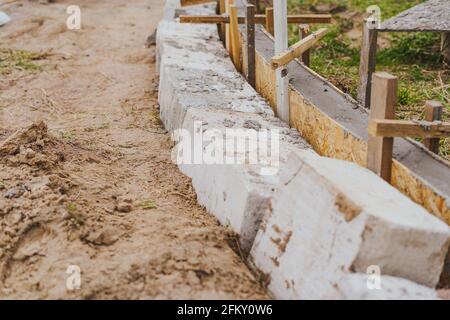 Concrete poured curb formed by timber formwork Stock Photo - Alamy