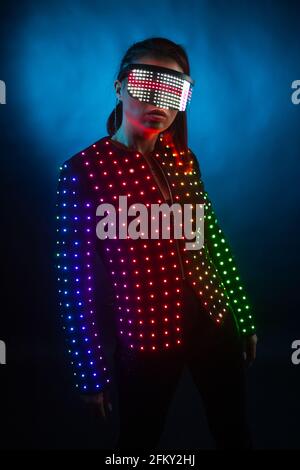 Girl in LED suit on a black background Stock Photo - Alamy