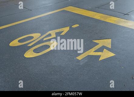 Bike lane with bike sign painting on asphalt in Geneva, Switzerland Stock Photo - Alamy