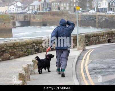 A person struggles against strong winds on Bull Wall in Dublin. Tens of ...