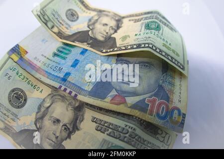 Closeup of Peruvian sol and US dollar bills on white background Stock ...