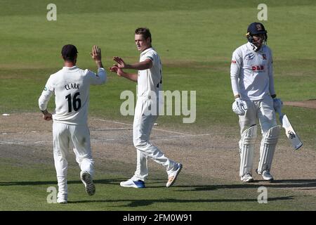 Joe Mennie of Lancashire (C) celebrates taking the wicket of Daniel ...