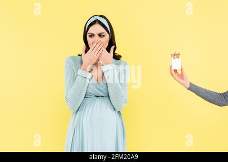 pregnant woman feeling disgust near piece of delicious cake isolated on ...